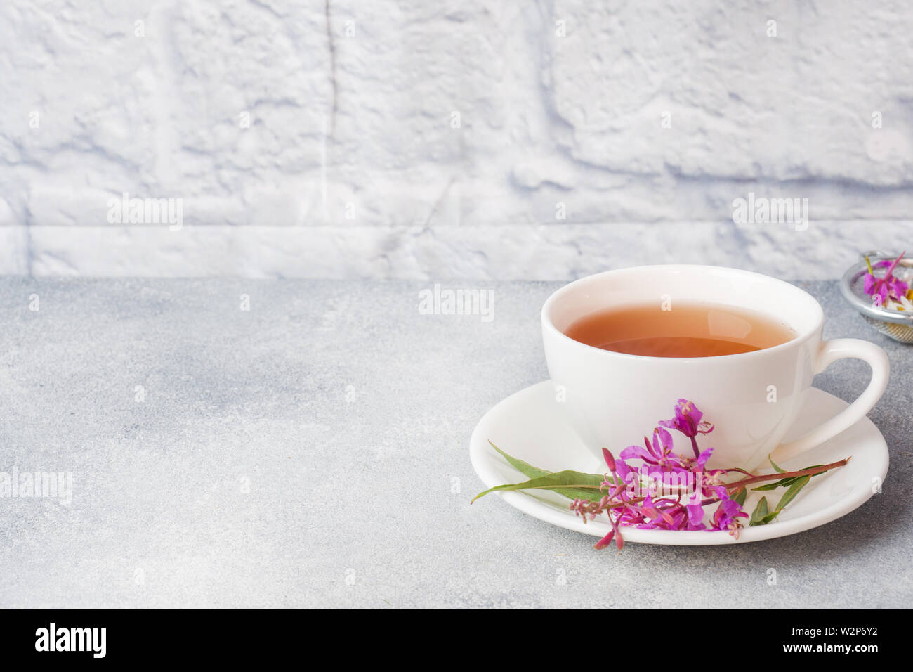 Useful herbal tea from fermented leaves fireweed on grey background ...