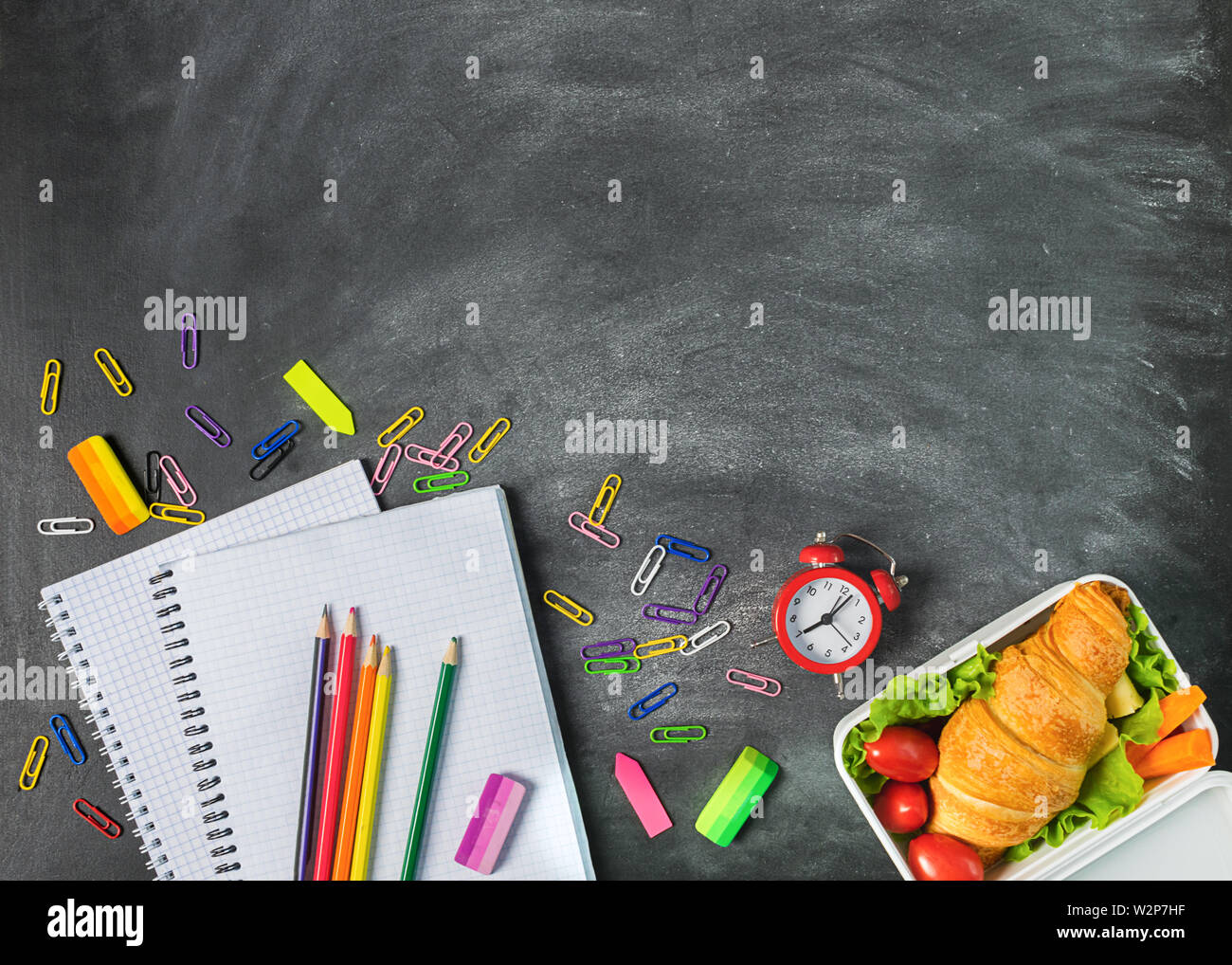 Sandwich teaching supplies notebook pen on a chalk board. Concept back ...