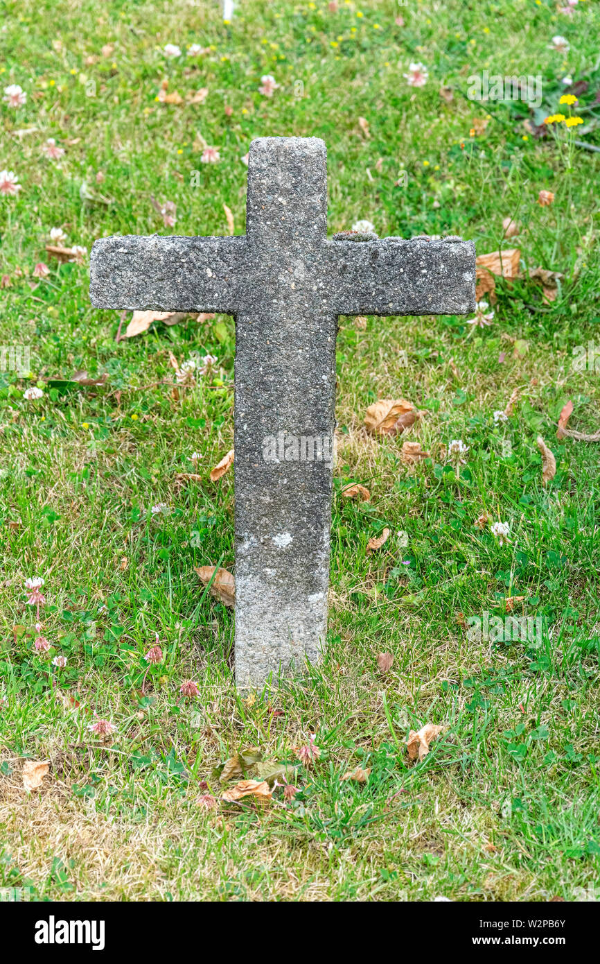 In the green grass stands an old concrete cross Stock Photo - Alamy