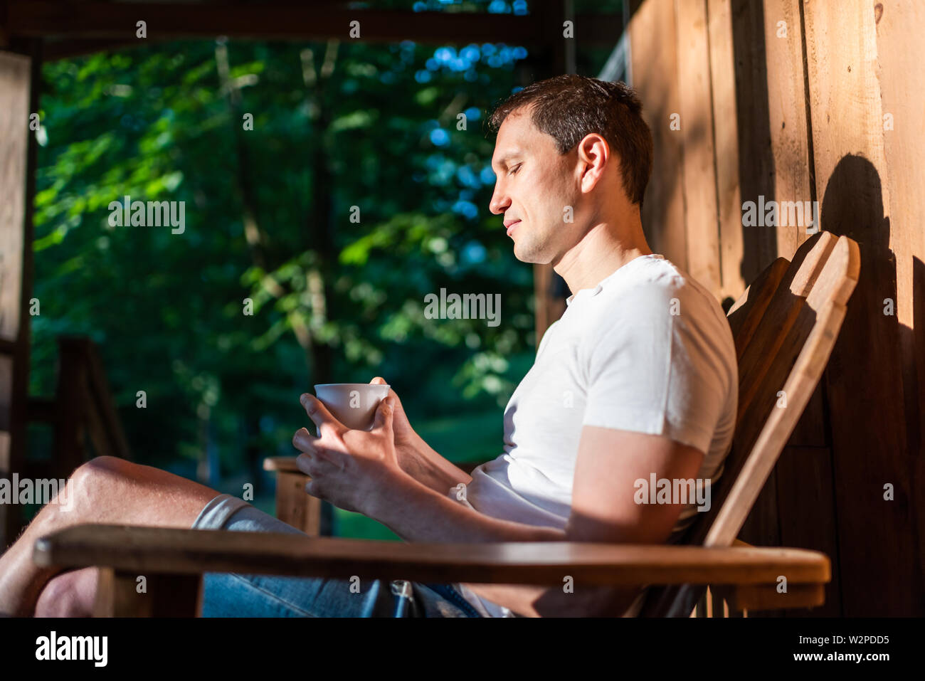 Man sitting on rocking chair hi-res stock photography and images - Alamy
