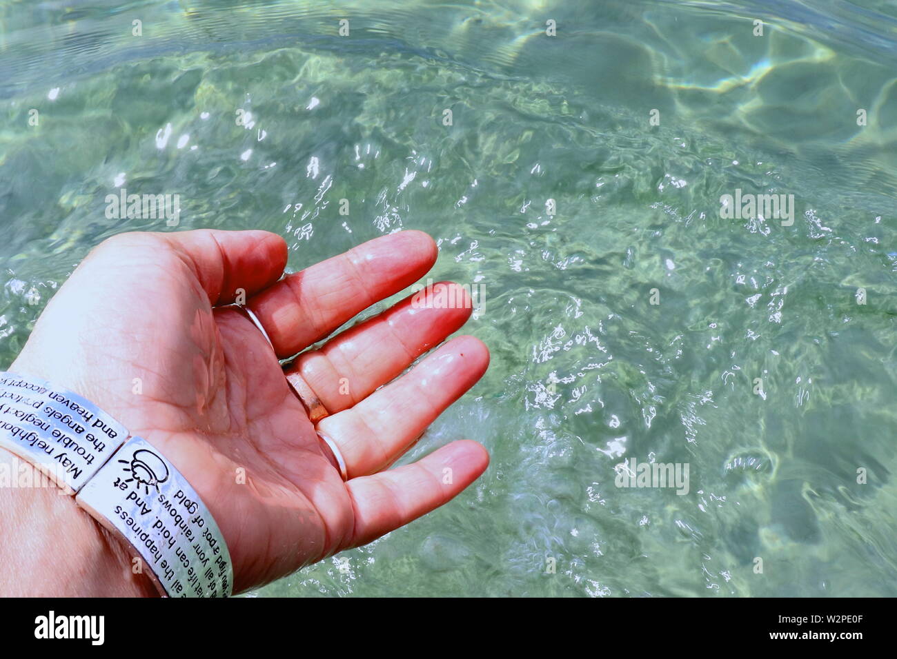 Hand wearing bracelets hi-res stock photography and images - Alamy