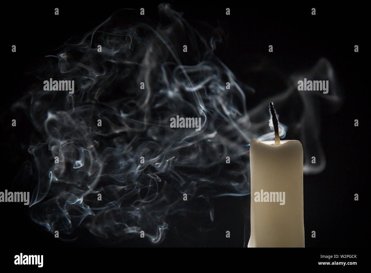 Smoke candle on a black background Stock Photo - Alamy