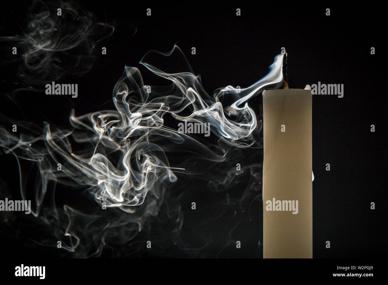 Smoke candle on a black background Stock Photo - Alamy