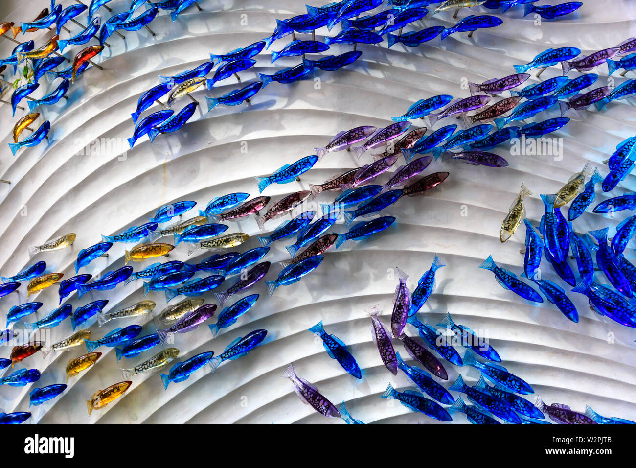 group of fish made by colorful plastic with white wall Stock Photo - Alamy