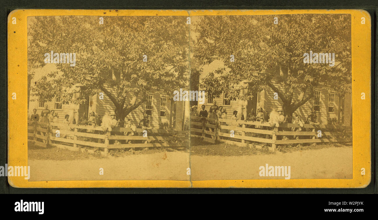 Adults and children posing behind the fences of their home, from Robert ...