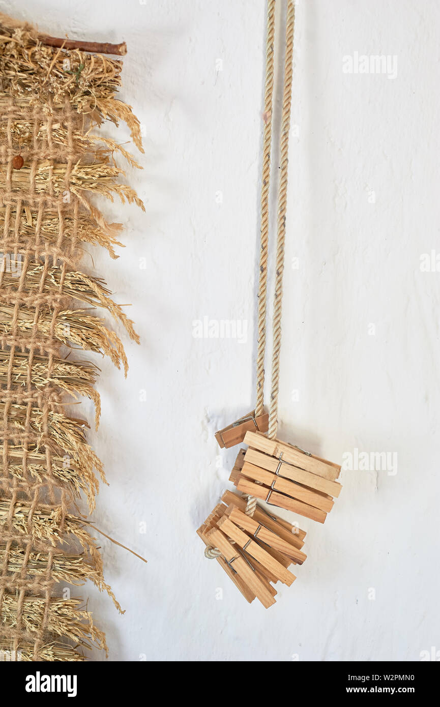 Wooden pegs hang on a rope.Village hut. Old ways of life. Retro Stock ...