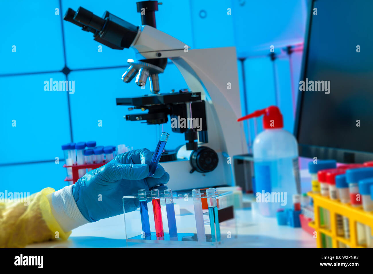 Scientific experiment in microbiological lab. Microscope and test tube ...