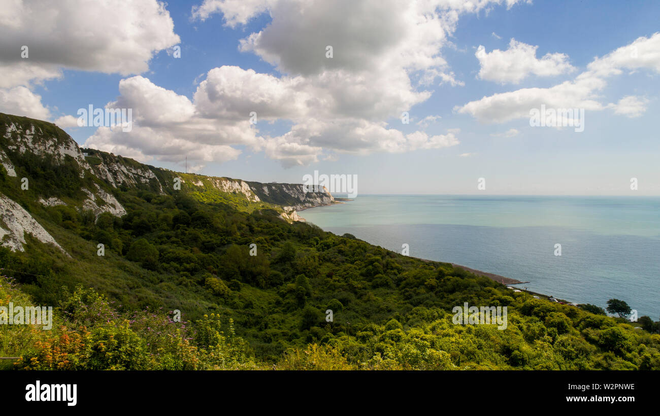 White cliffs, the Kent coast at Folkestone under a blue sky on a ...