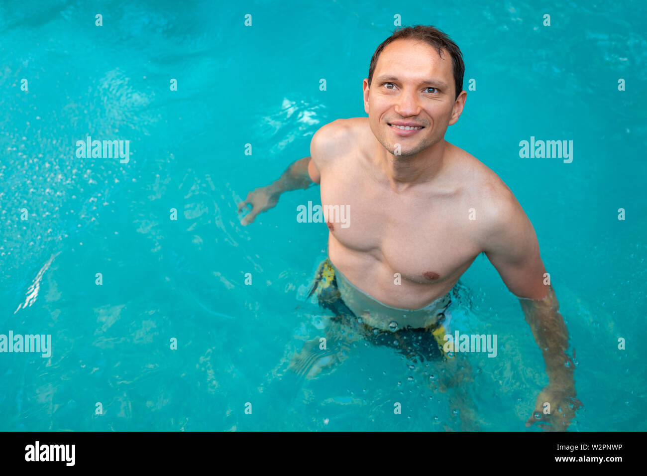 Young man swimming in Japanese spa in Japan onsen hot spring pool with ...