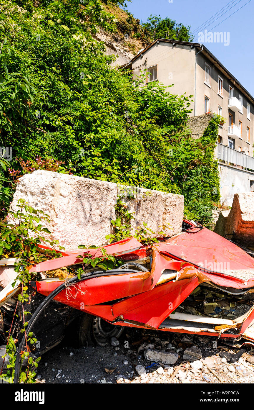 Wreck of a car crushed by a wall after a landslide, Saône river quays ...