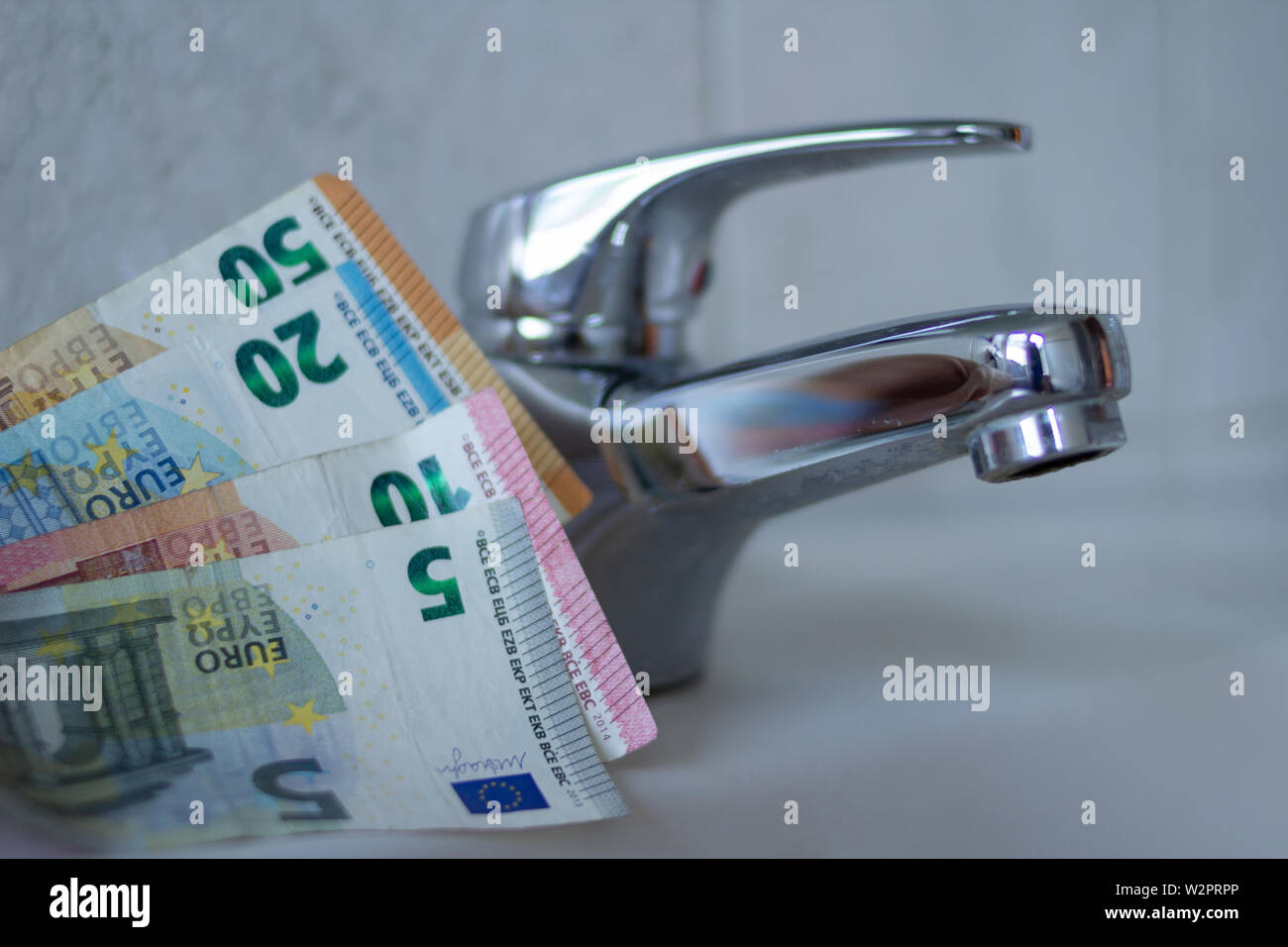 Side view bathroom sink with euro banknotes Stock Photo - Alamy