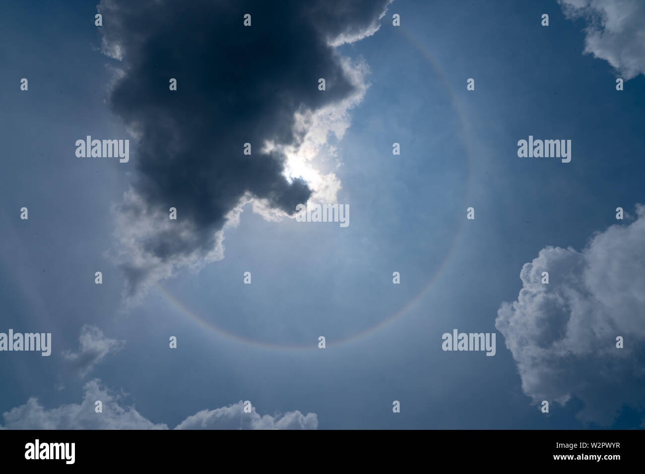 The sun shines with the blue summer sky with white clouds fluffy ...