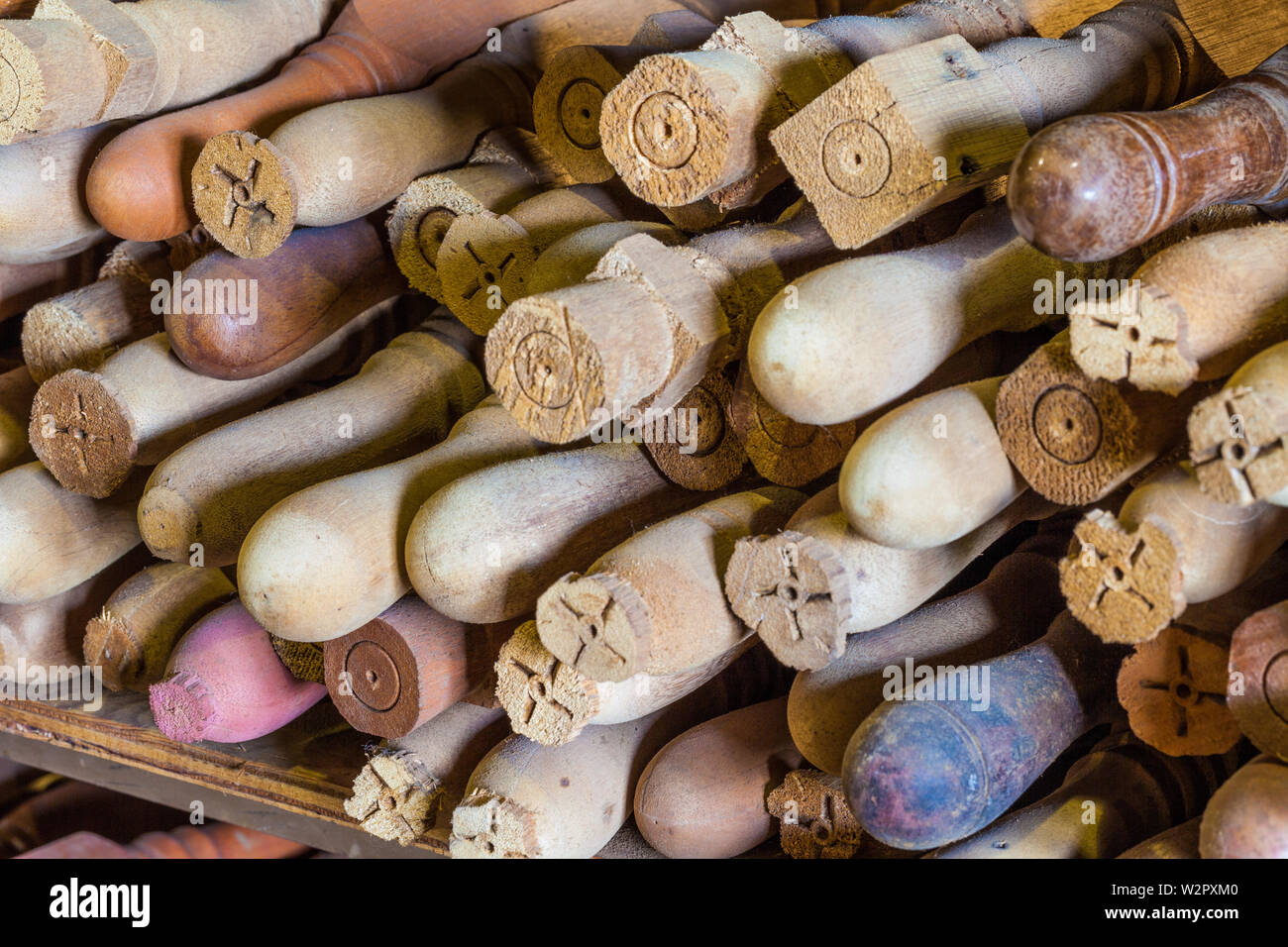Ship wheel handles in varying stages of manufacture from a wood lathe ...