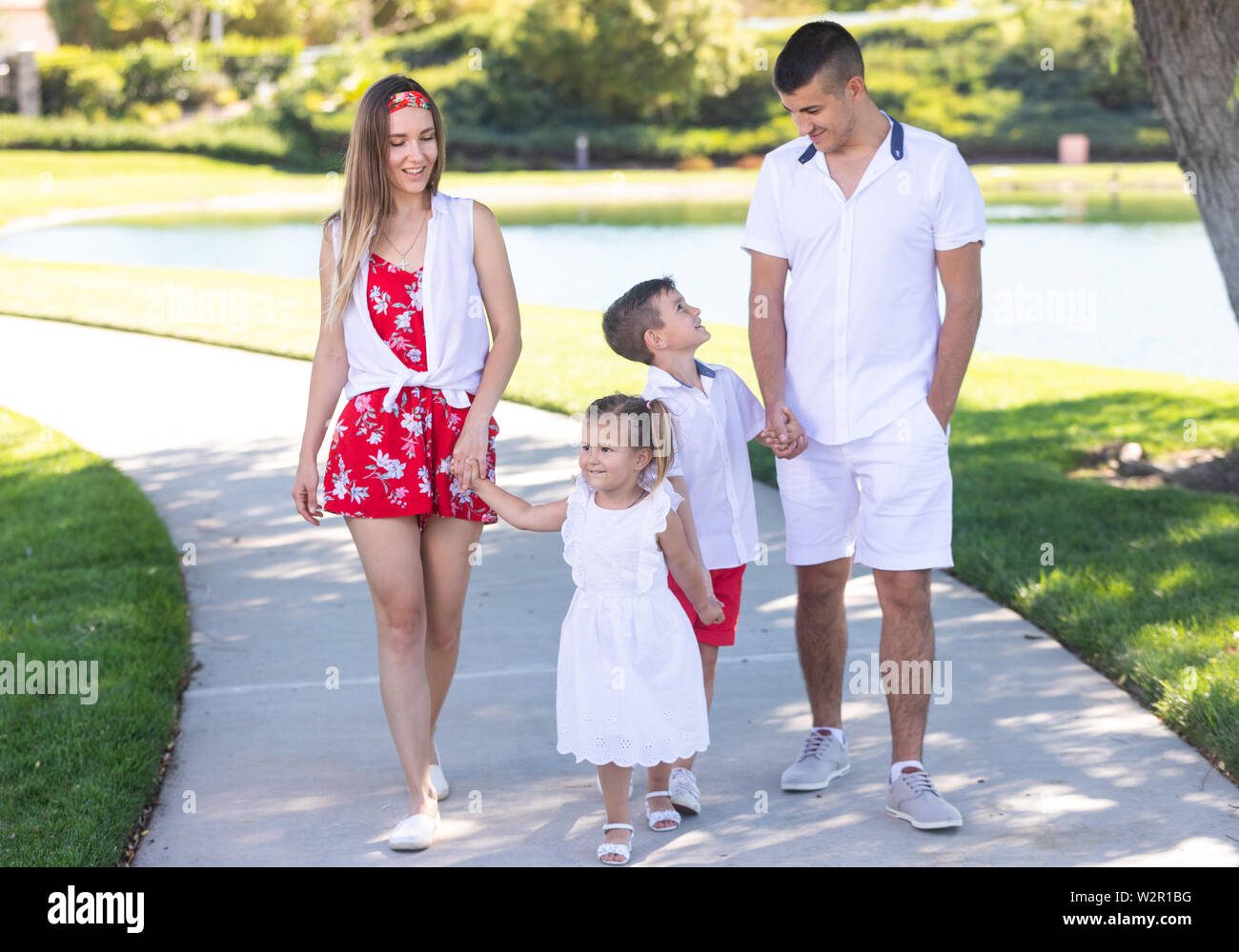 Happy family having fun together in the beautiful park Stock Photo - Alamy