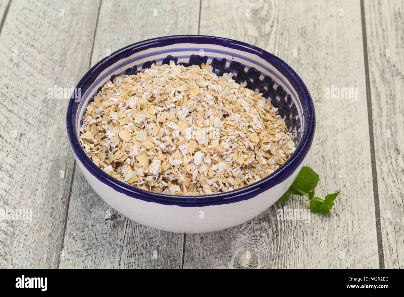 Raw oats in the bowl for breakfast Stock Photo - Alamy