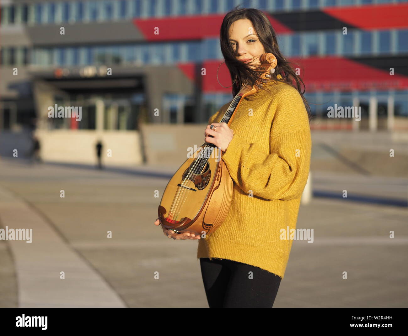 Mandolinist plays his mandolin in street style outfit in new modern ...