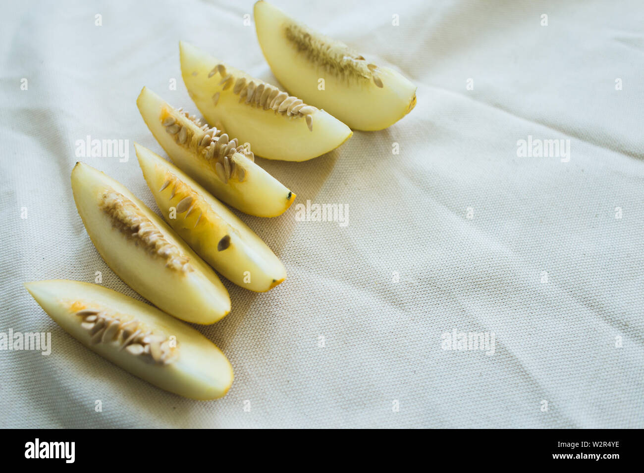 A group of brightly lit melon slices. seasonal summer fruits Stock ...