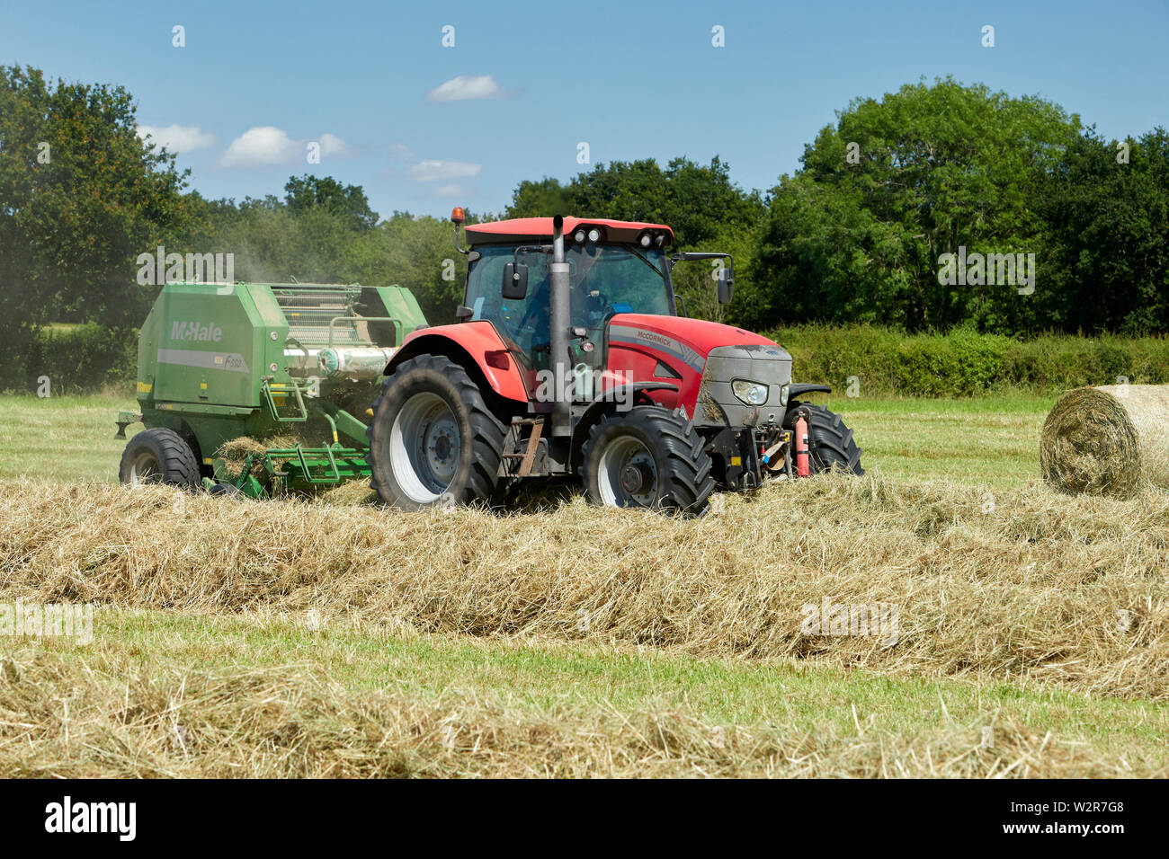 McCormick MTX150 tractor with a McHale F550 bailer Stock Photo - Alamy