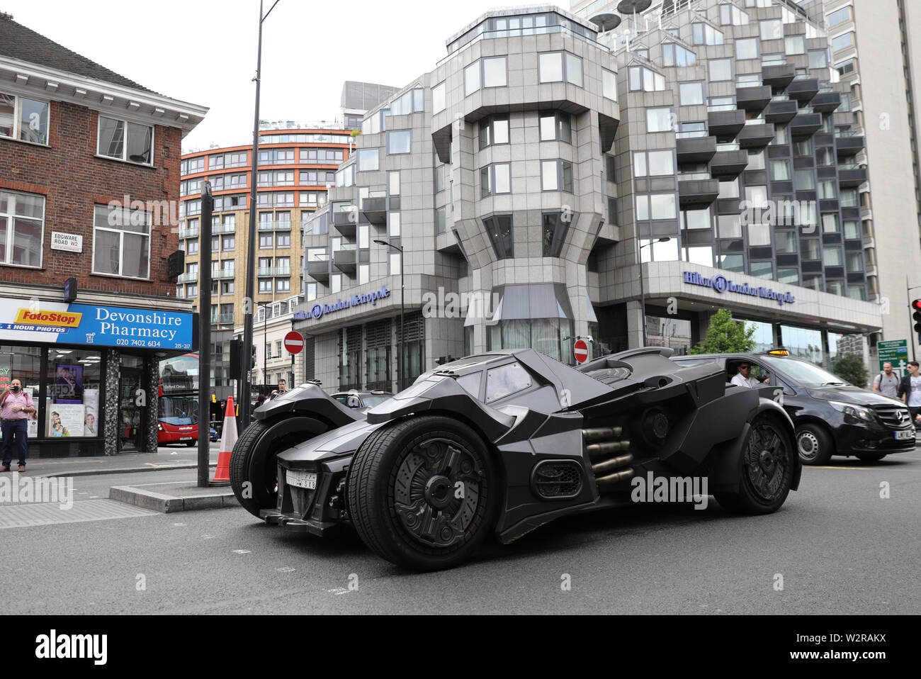 A mock Batmobile makes its way down Edgware Road, west London Stock ...