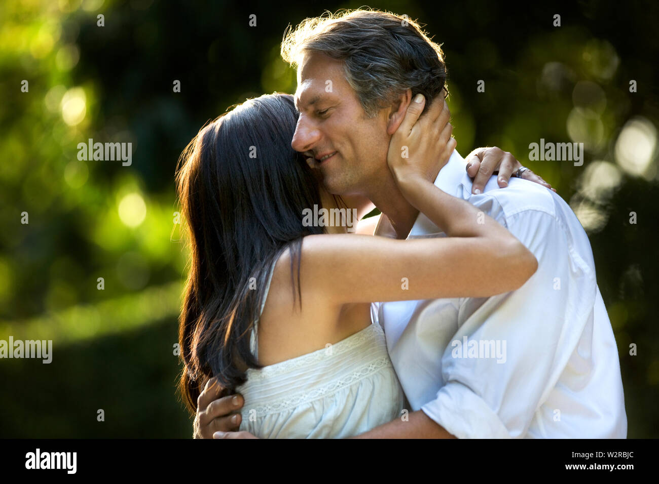 Husband and wife stand in embrace Stock Photo - Alamy