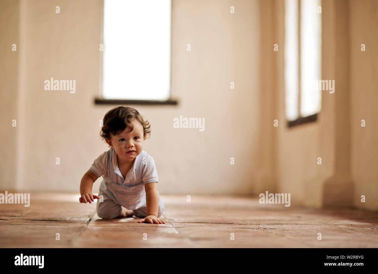 Toddler crawling in the hallway Stock Photo - Alamy