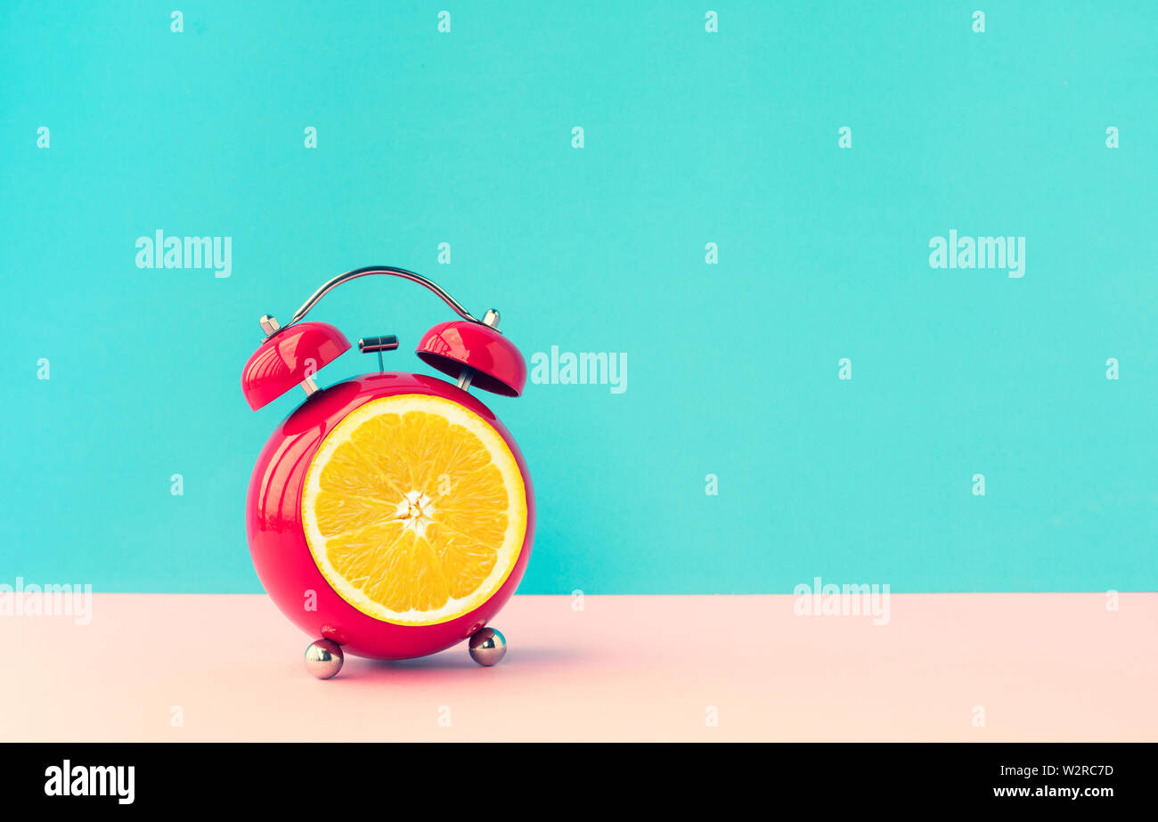 Summer time concepts ideas with orange alarm clock on blue pastel ...