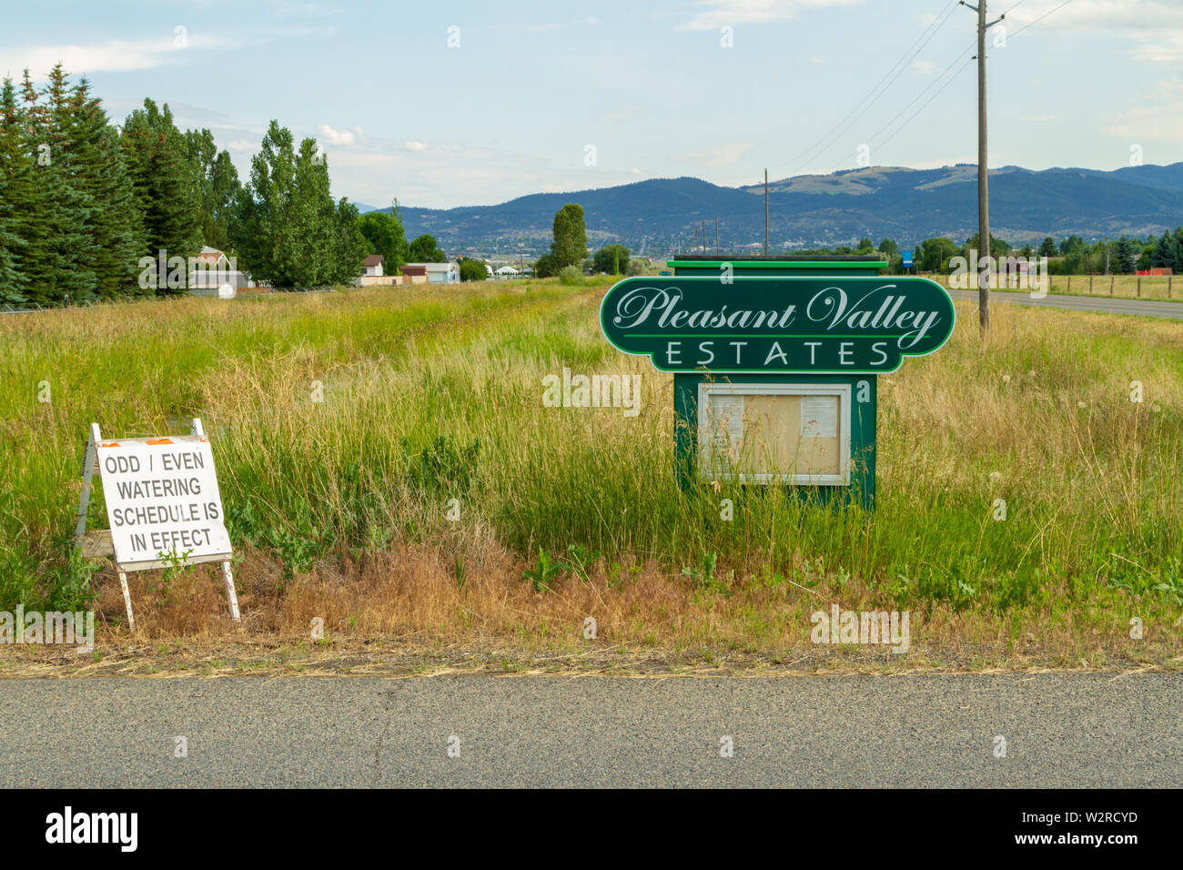 A watering schedule sign placed at the entrance to a subdivision to ...