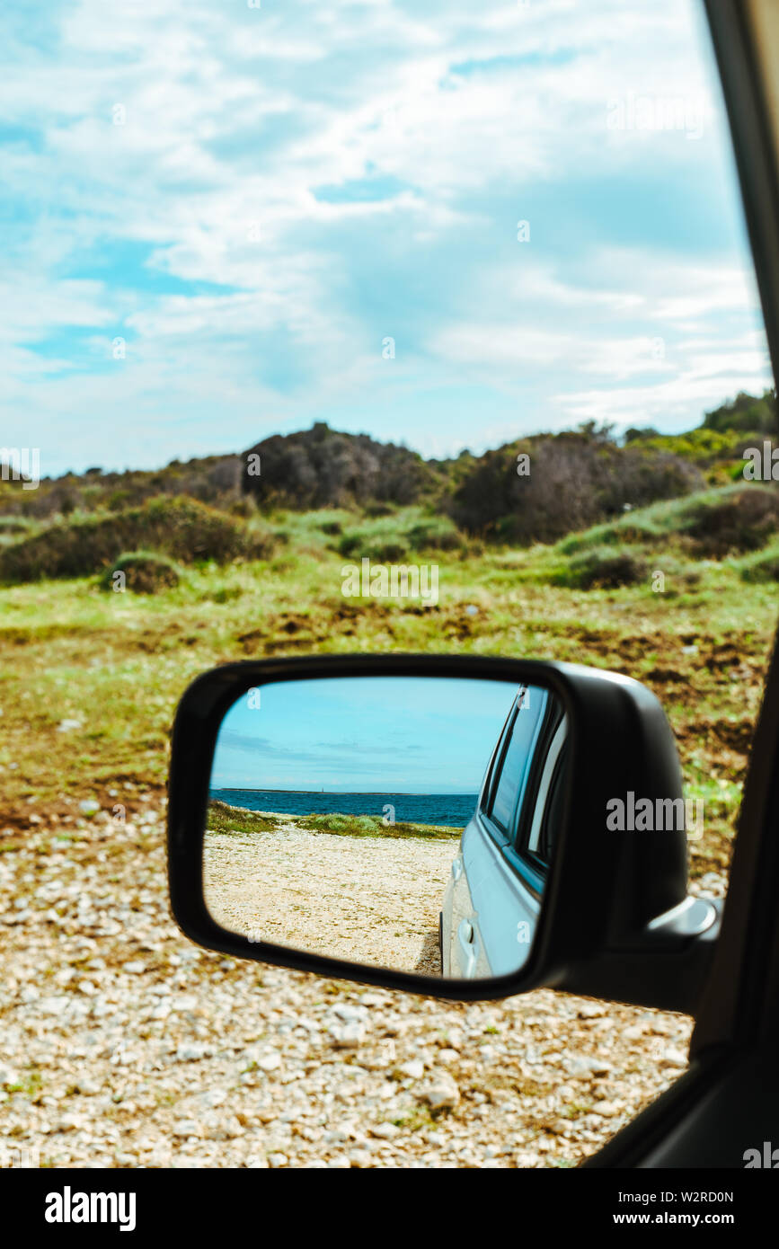 sea reflection in car rear mirror. road trip Stock Photo - Alamy