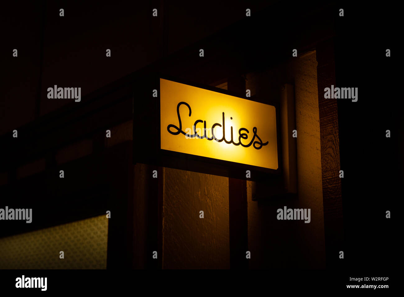 lluminated Ladies restroom sign in cursive font, Many Glacier Hotel ...