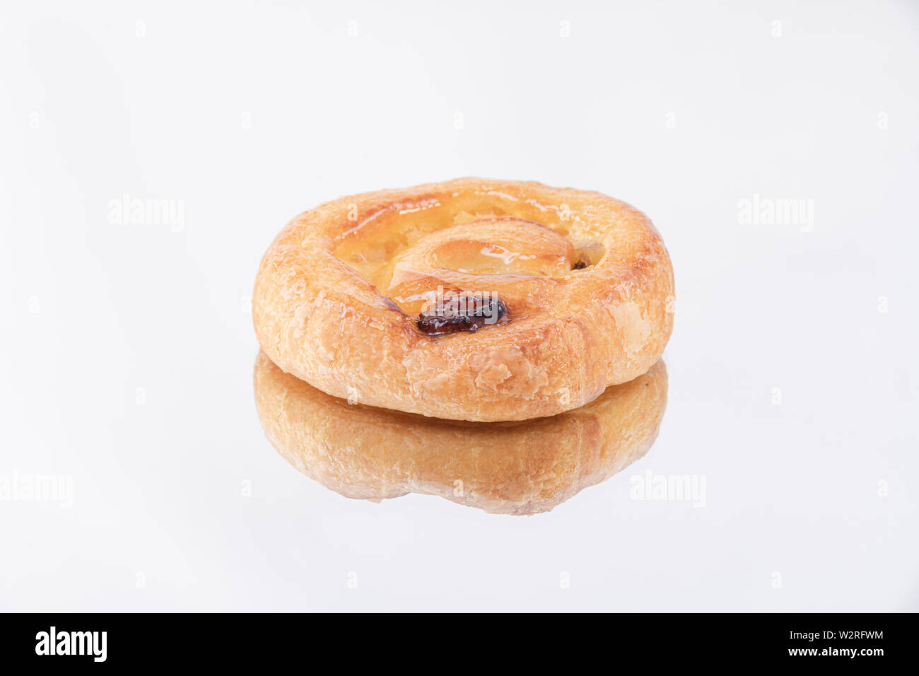Tasty roll of freshly baked puff pastry with honey on top isolated on a ...