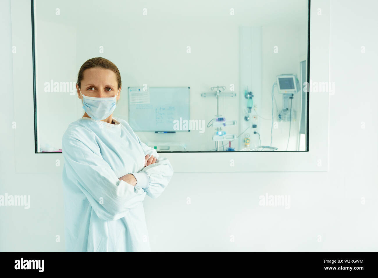 Nurse in hospital near surgery room glass window Stock Photo - Alamy