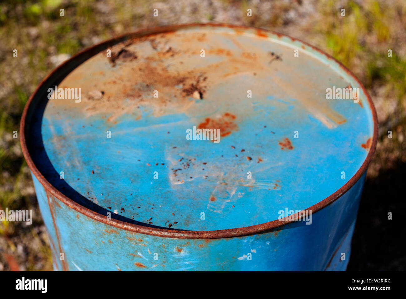 a blue rusty oil barrel in nature Stock Photo - Alamy
