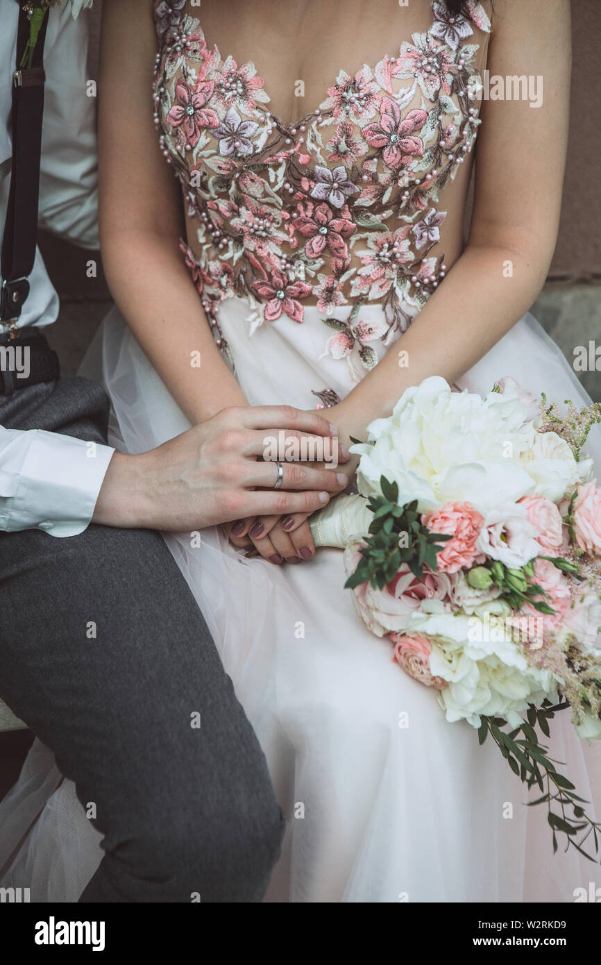 The groom holds the hand of the bride Stock Photo - Alamy
