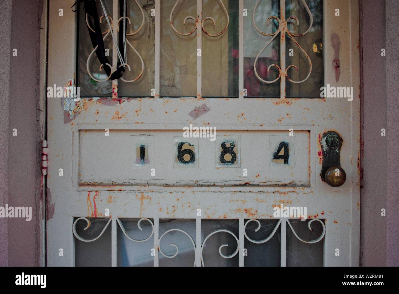 Closeup of an old rusty metal door with number "1684" on it Stock Photo ...