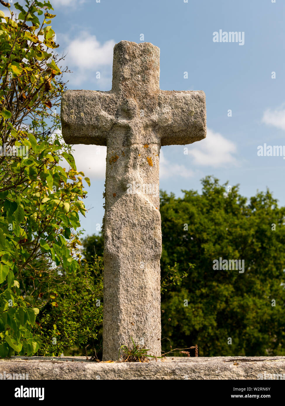 old stone cross with trees in the background on a sunny day Stock Photo ...