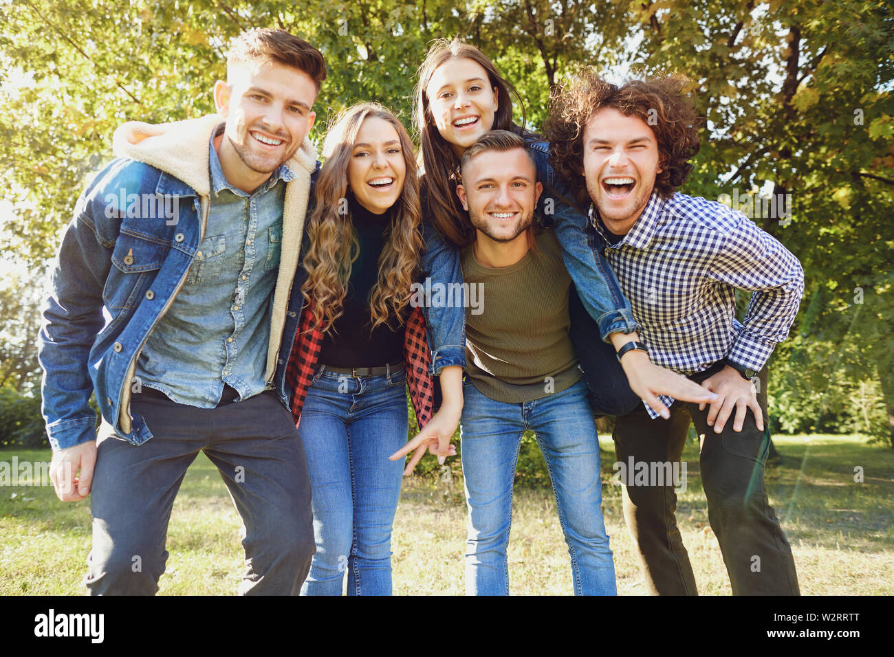 Happy funny friends are laughing at the park. Friendship of young ...