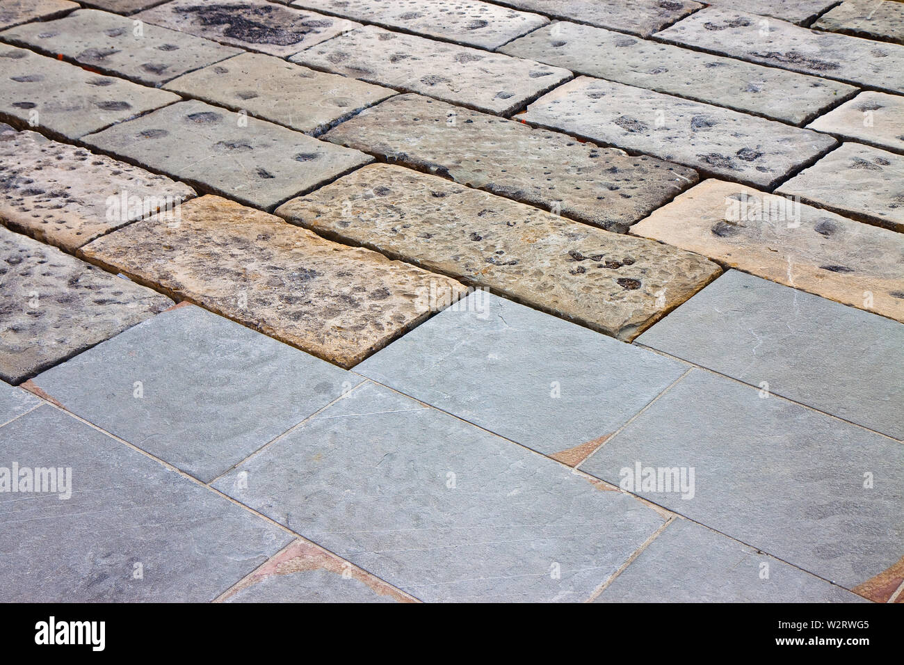 Restoratione of an old stone paving with new carved paving made with ...
