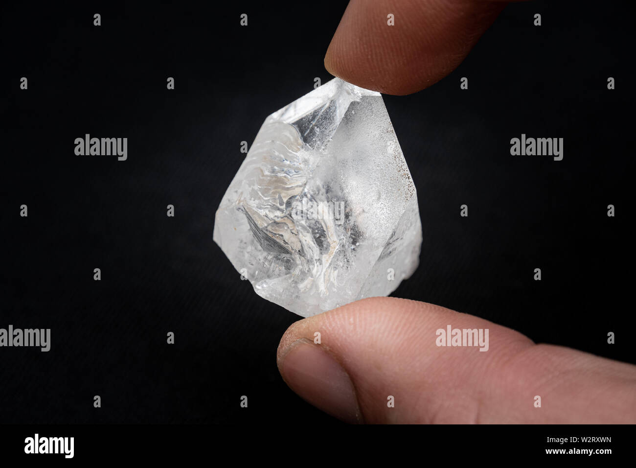 Holding a dob rough diamond formed by volcanic heat and pressure inside ...