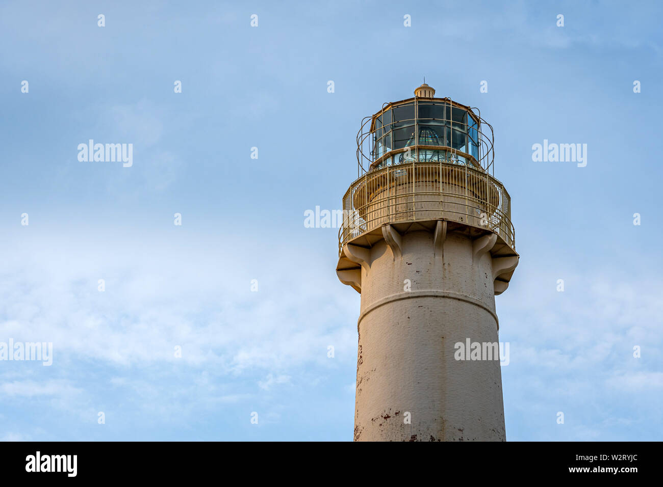 Lighthouse on a light blue sky background Stock Photo - Alamy
