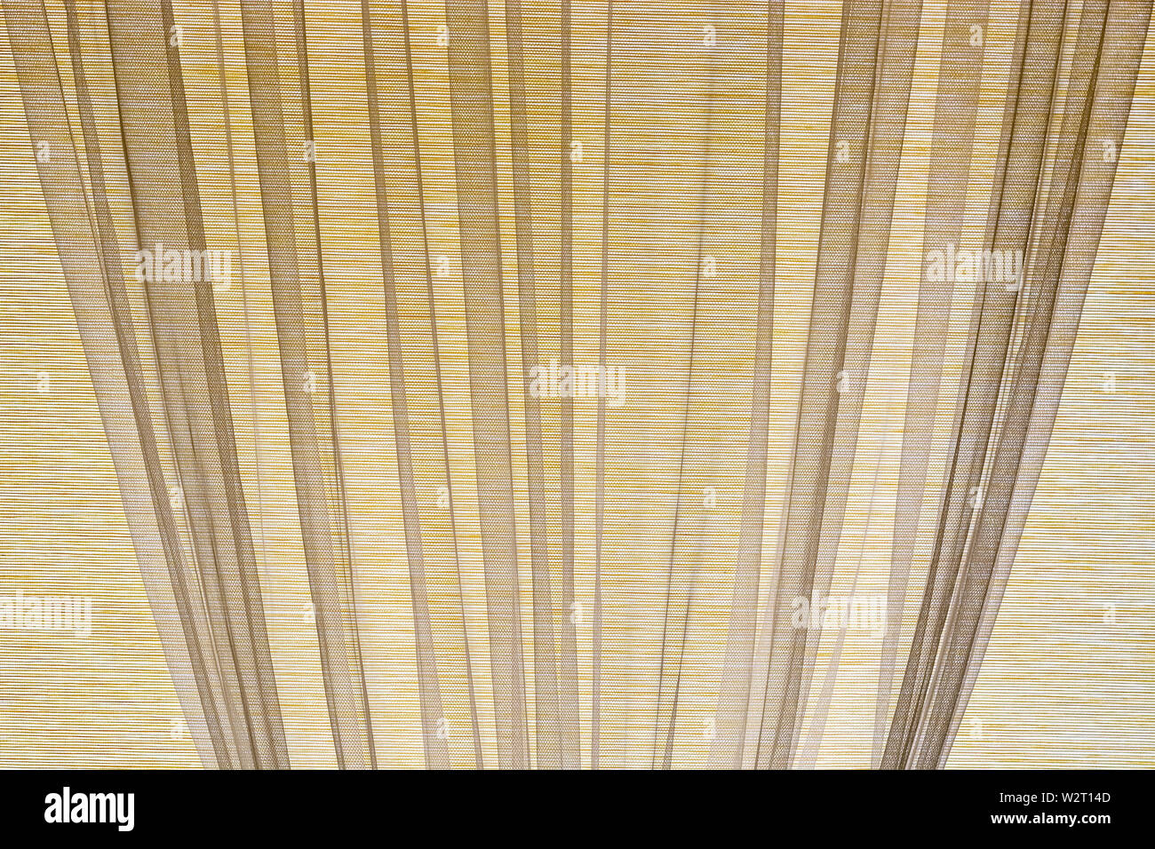 Curtains made of beige fabric on the window, for use as a texture and ...