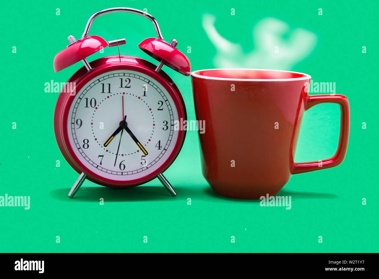 Coffee with steam and and alarm clock for getting ready for new daily ...