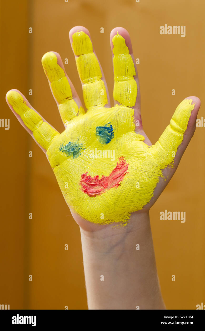 yellow sun painted on hand Stock Photo - Alamy