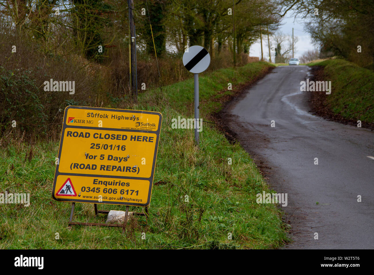 Yellow Suffolk Highways sign on grass verge warning of road closure ...