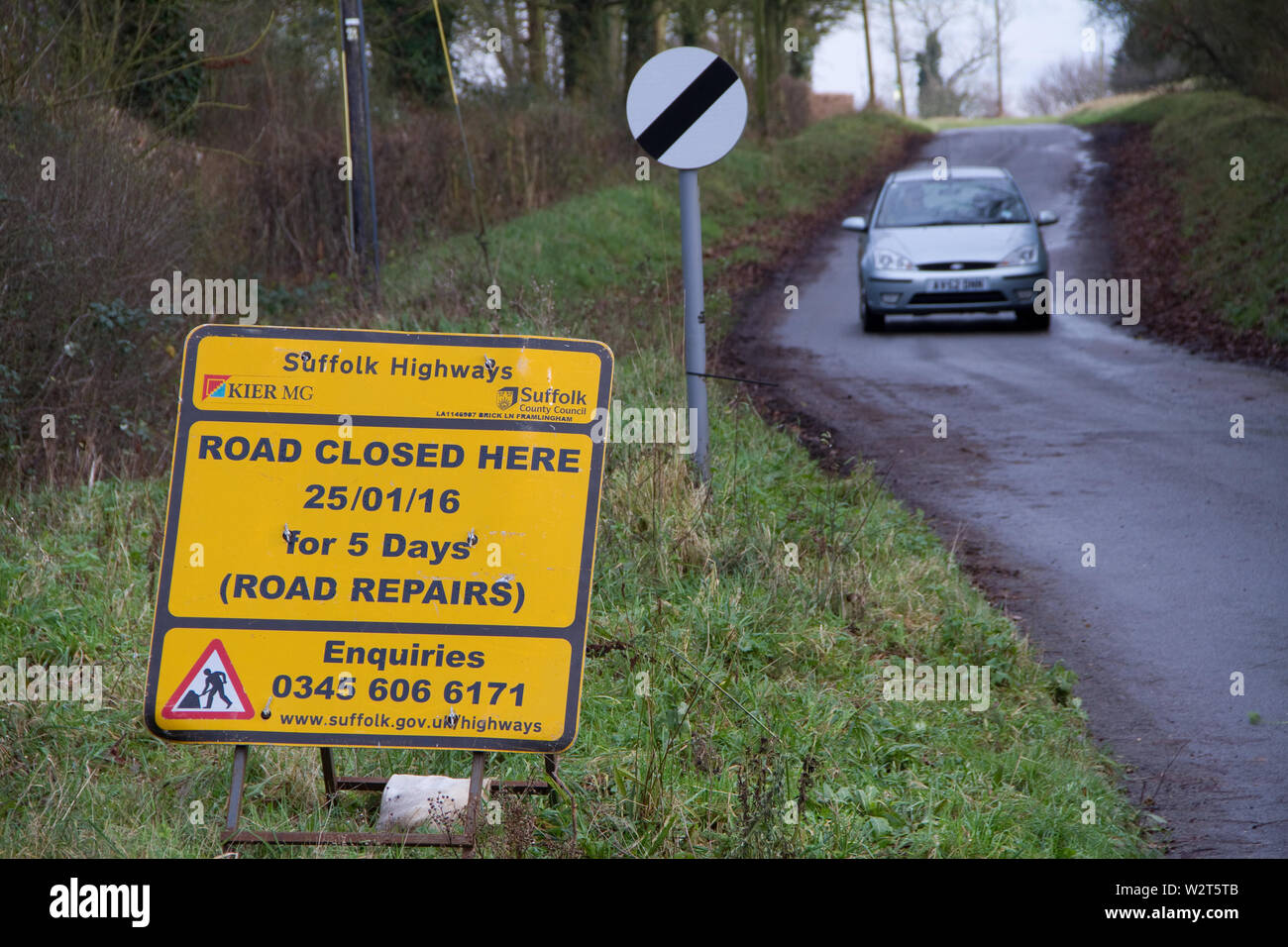 Yellow Suffolk Highways sign on grass verge warning of road closure ...
