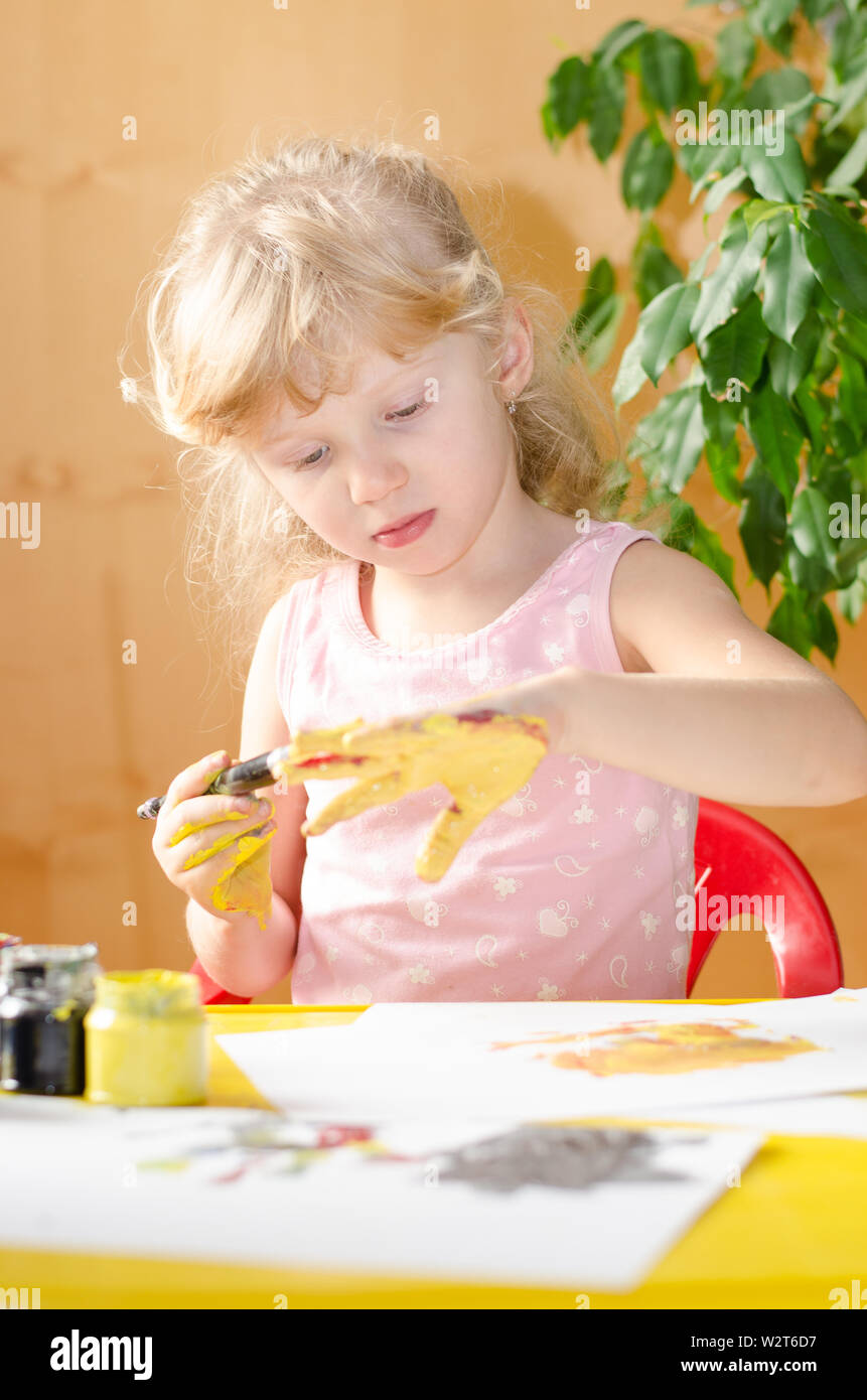 blond girl painting with brush Stock Photo - Alamy