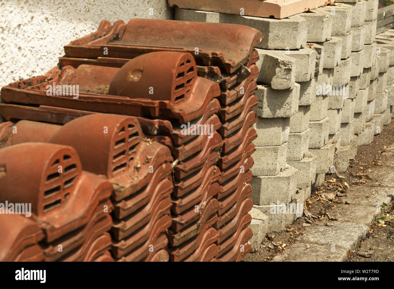 piles of roof tiles and cement paving stones at construction site Stock ...