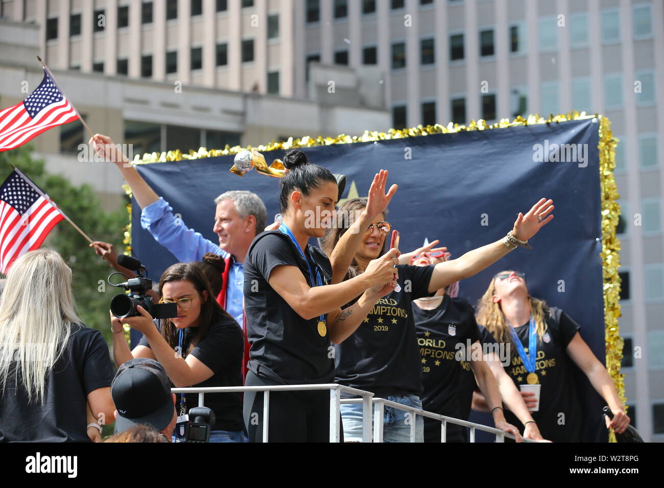 NEW YORK, NEW YORK - JUNE 30: Ali Krieger takes photos of the crowds as ...