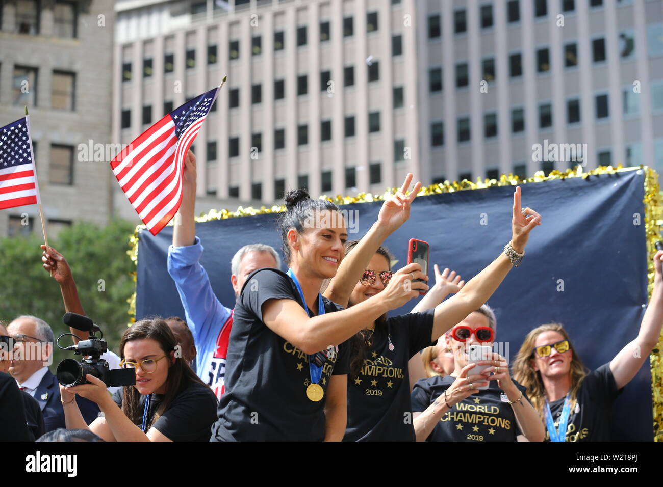 NEW YORK, NEW YORK - JUNE 30: Ali Krieger takes photos of the crowds as ...