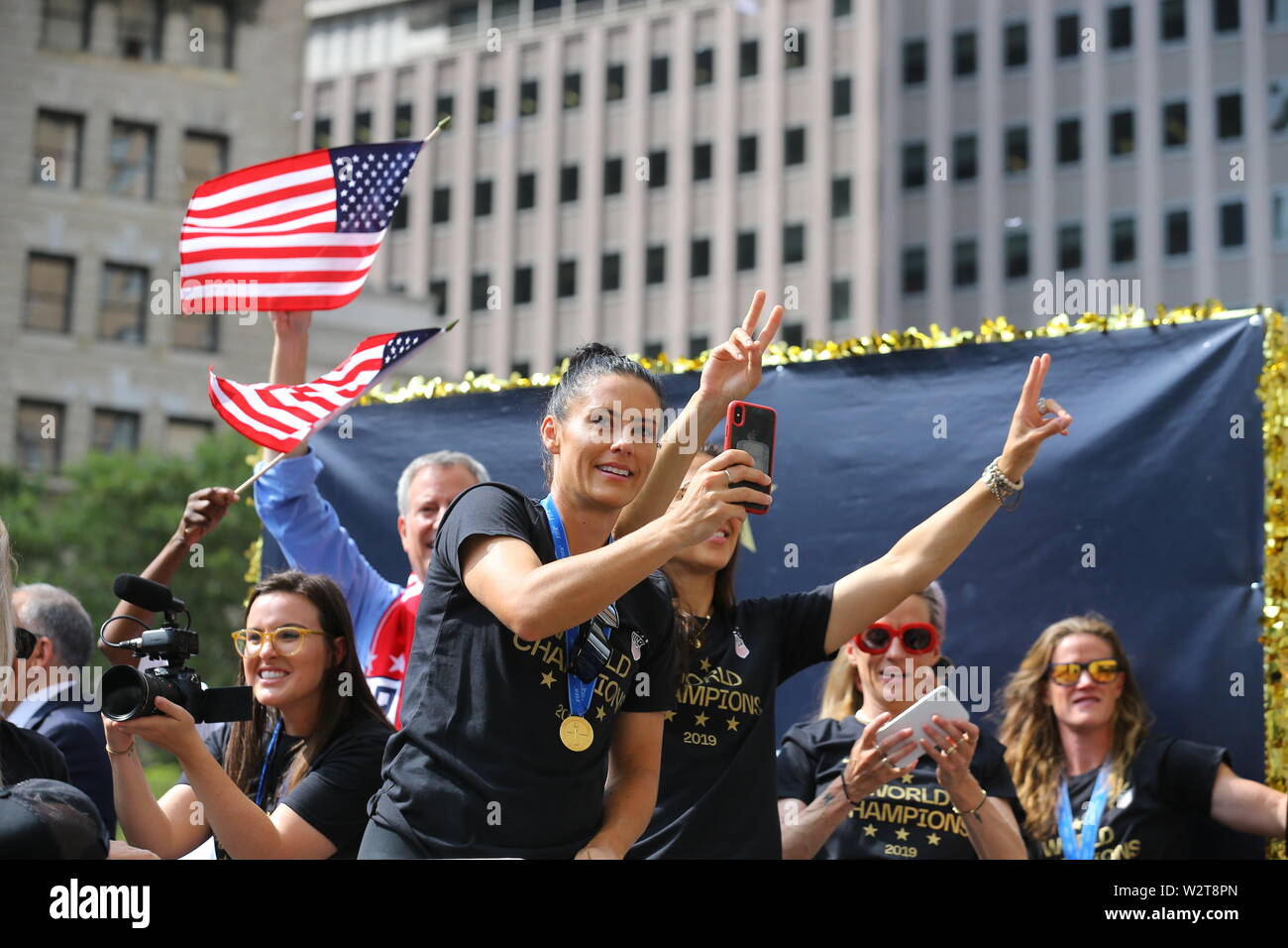 NEW YORK, NEW YORK - JUNE 30: Ali Krieger takes photos of the crowds as ...