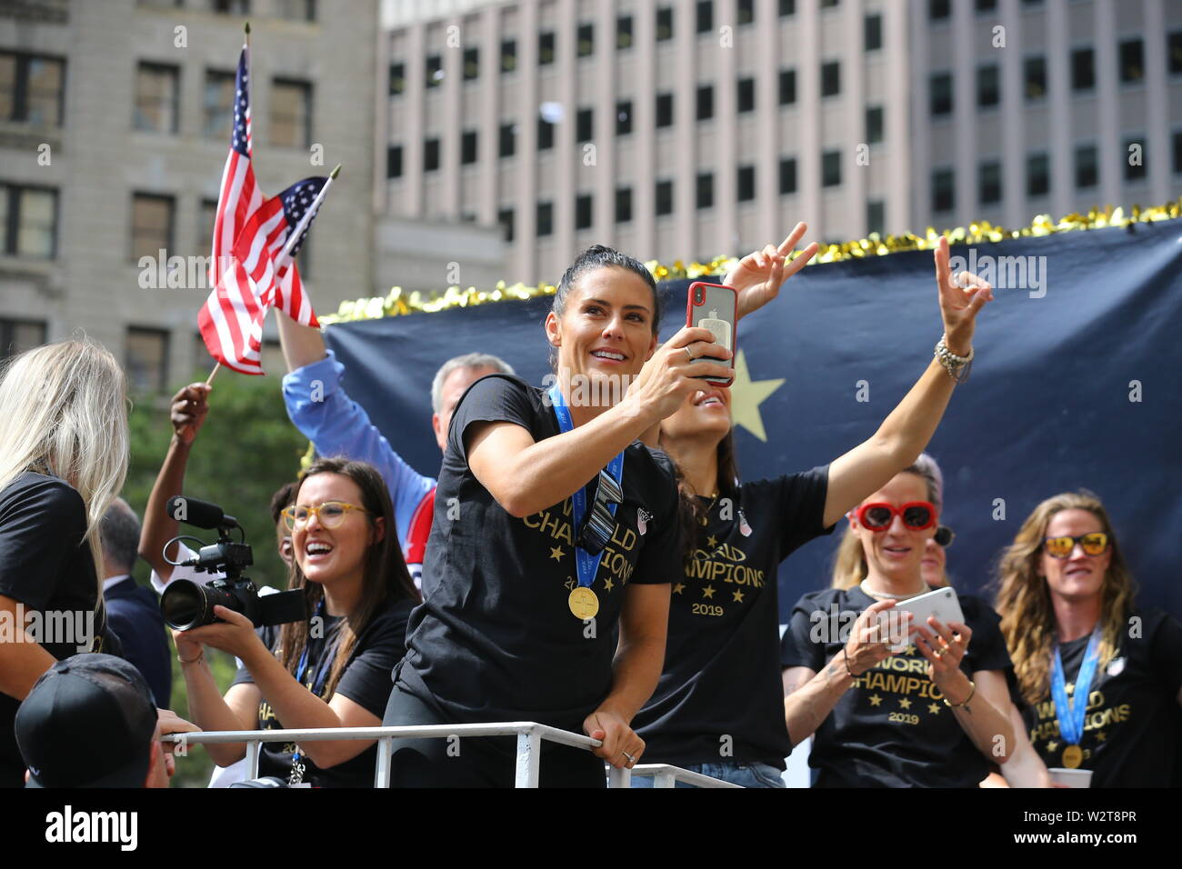 NEW YORK, NEW YORK - JUNE 30: Ali Krieger takes photos of the crowds as ...